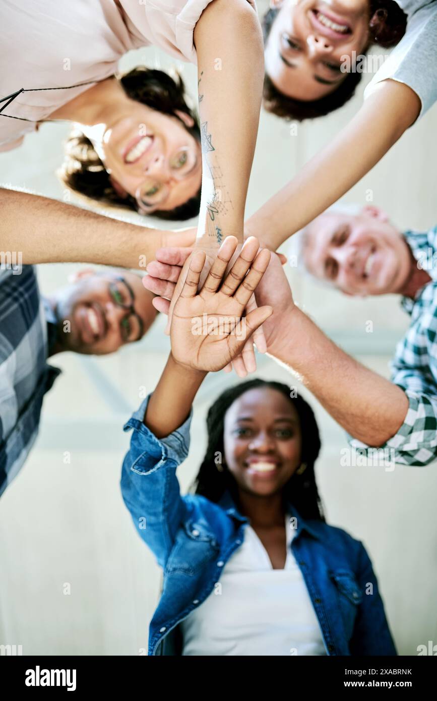 Business people, portrait and hands stack with low angle, teamwork and connection in huddle with ...