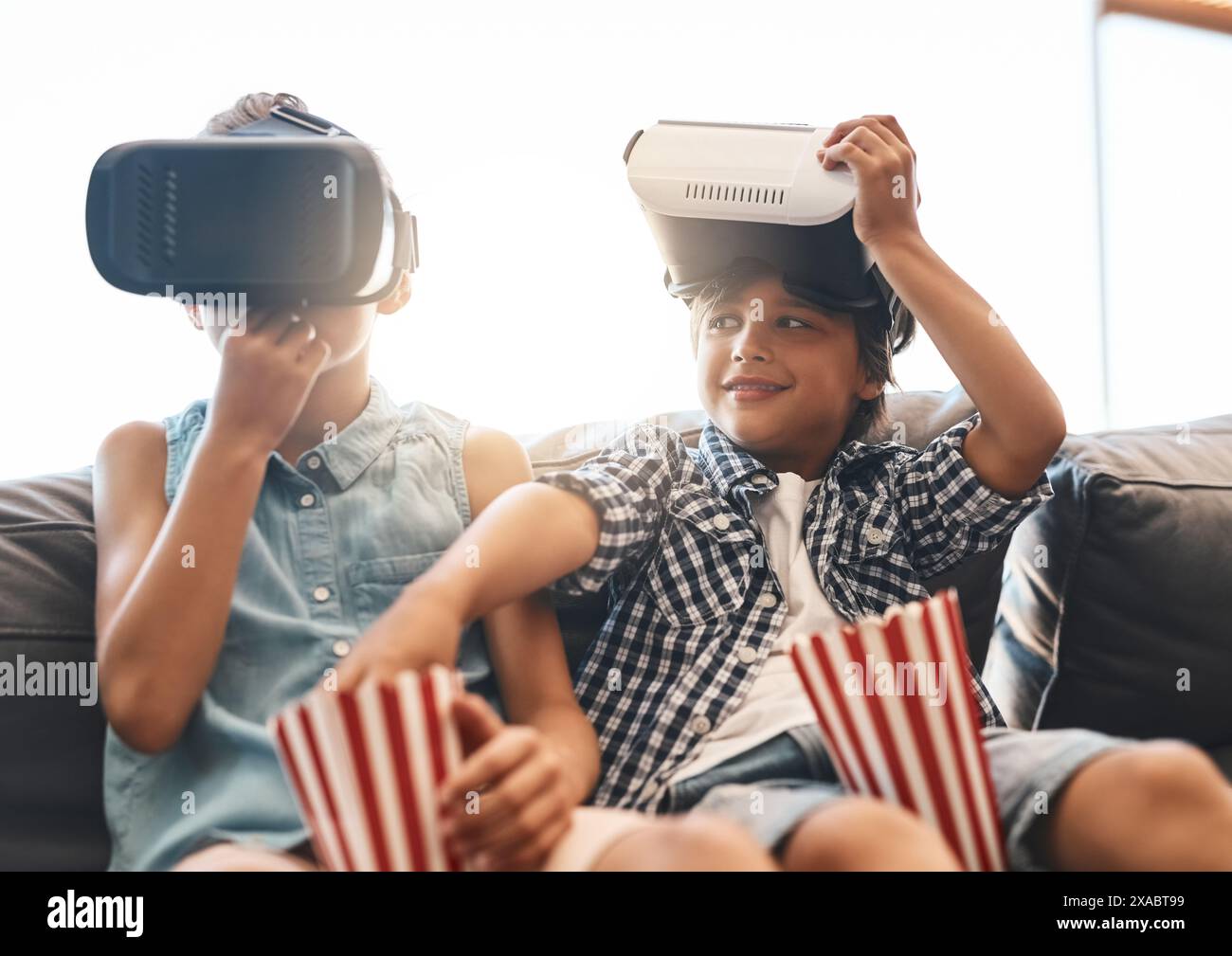 Brother, stealing popcorn and virtual reality headset in home or cyber ... Brother, stealing popcorn and virtual reality headset in home or cyber ...