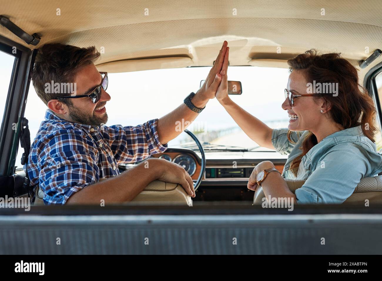 Couple, high five and car for travel, road trip and destination ...