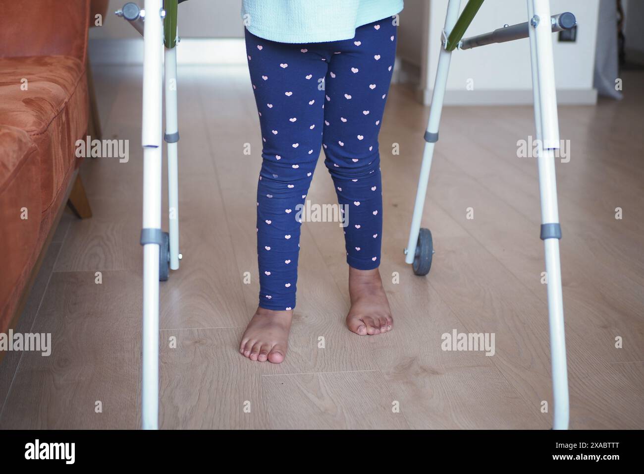 child with walking frame and knee orthosis indoor Stock Photo - Alamy