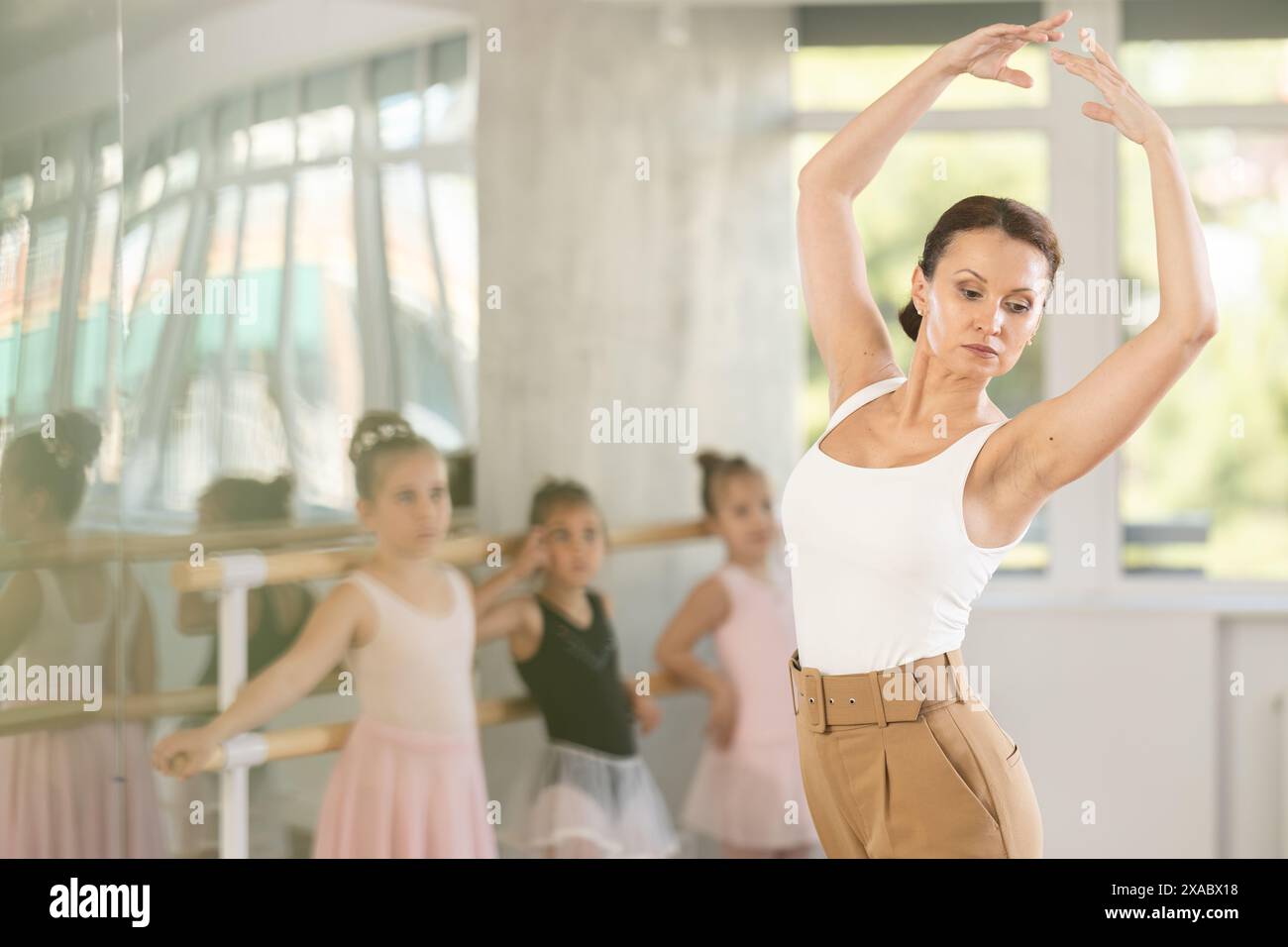 Female teacher shows choreography to group of girls Stock Photo - Alamy
