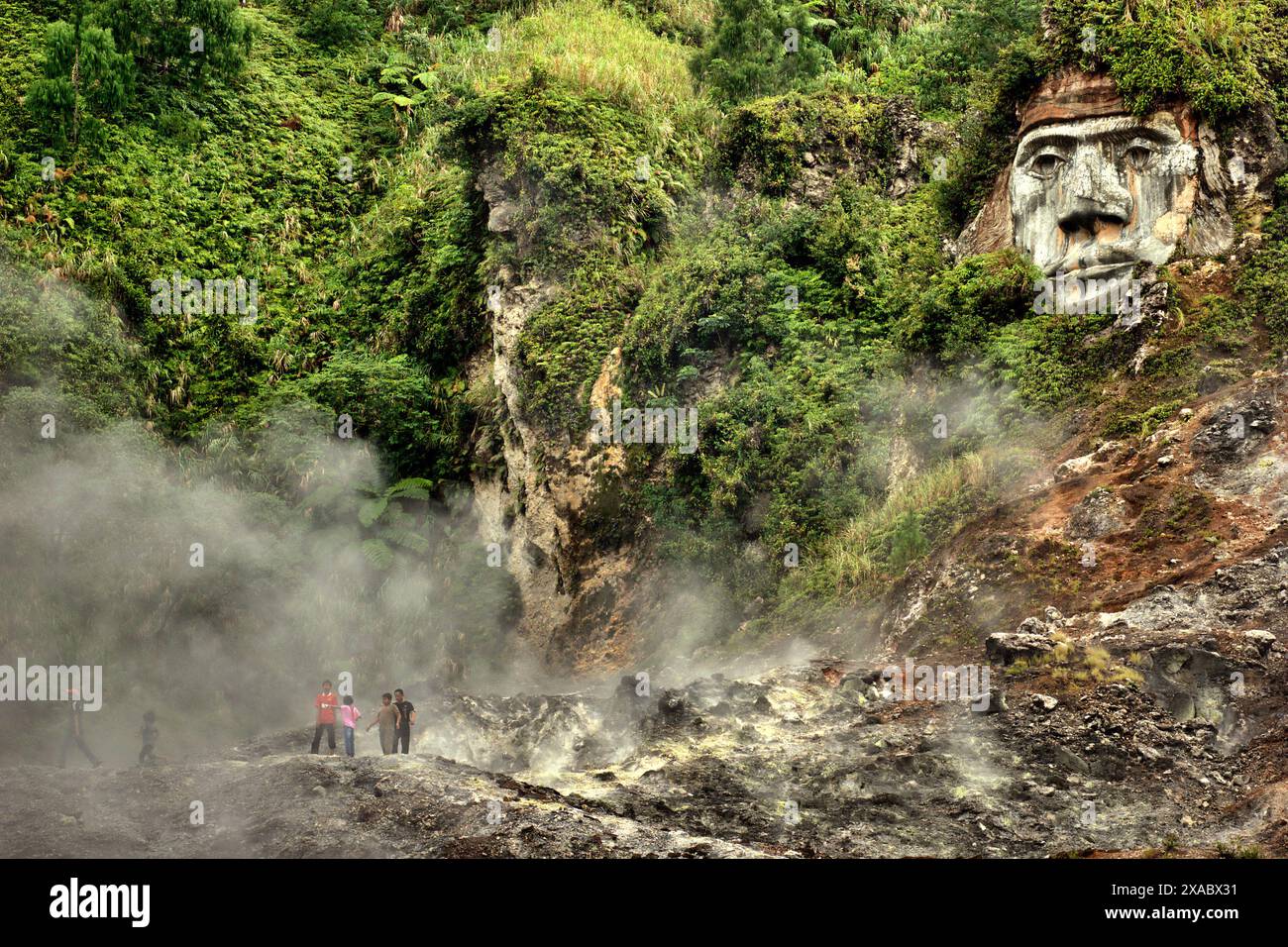Visitors having recreational time on fumarole field, below sculptural ...