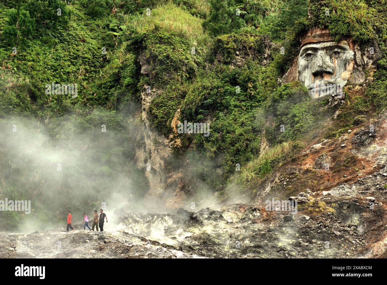 Visitors having recreational time on fumarole field, below sculptural ...