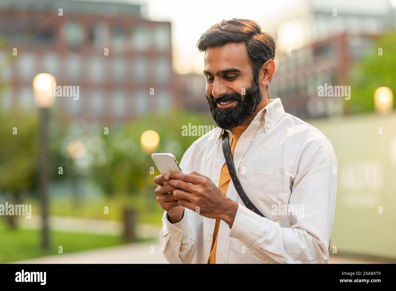 Bearded man connecting smartphone hi-res stock photography and images ...