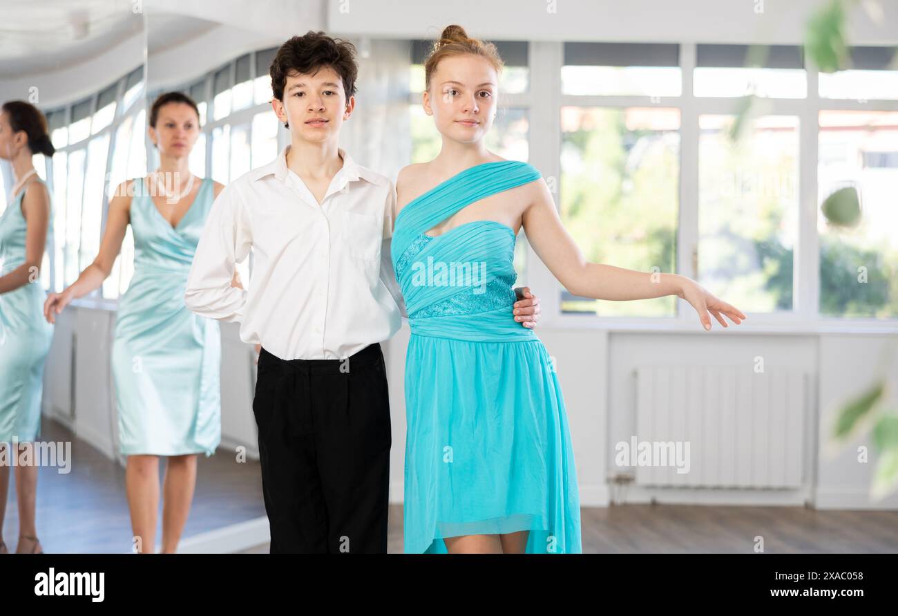 Couple of successful teenage dancers performing curtsy and bow after ...