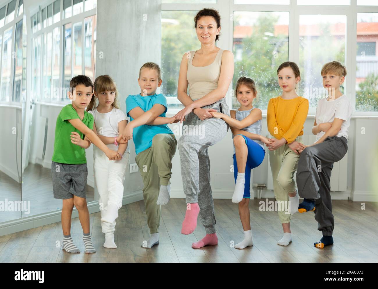 Preteen children and doing cancan dance together with female trainer ...