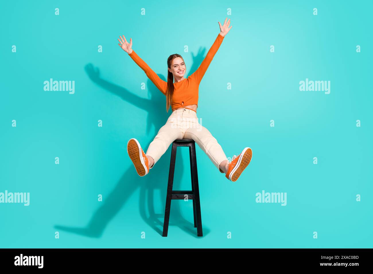 Full size photo of friendly girl dressed orange shirt white pants ...
