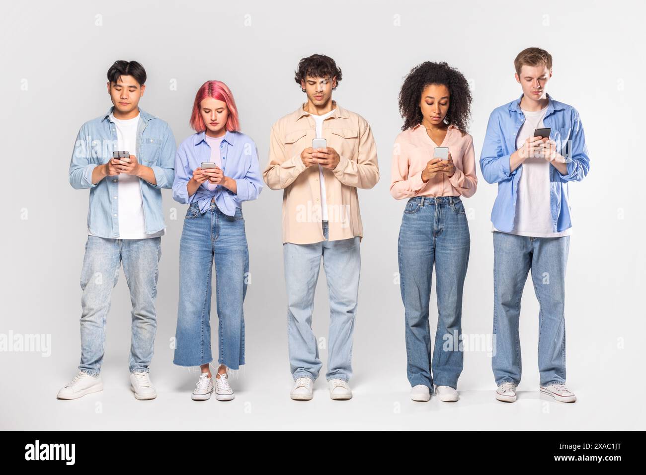 Five Diverse Young Adults Using Smartphones Against White Background ...