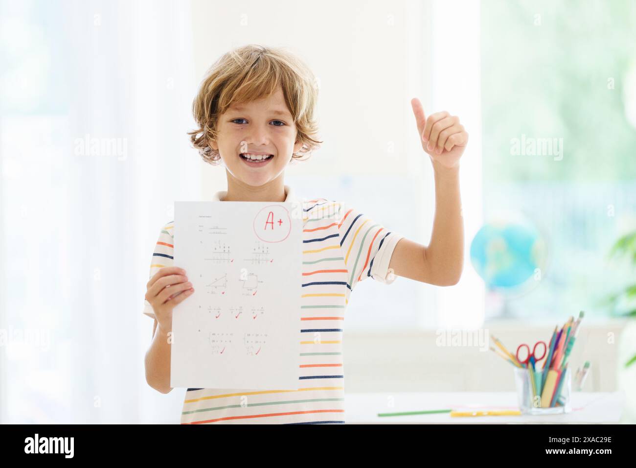 Student happy with exam paper classroom hi-res stock photography and ...