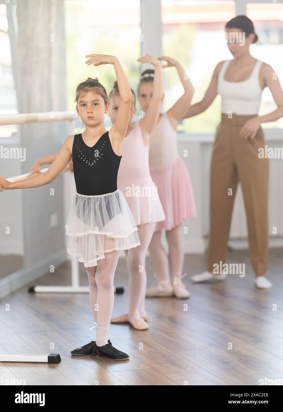 Fourth position - little girls learn ballet at choreography lesson ...