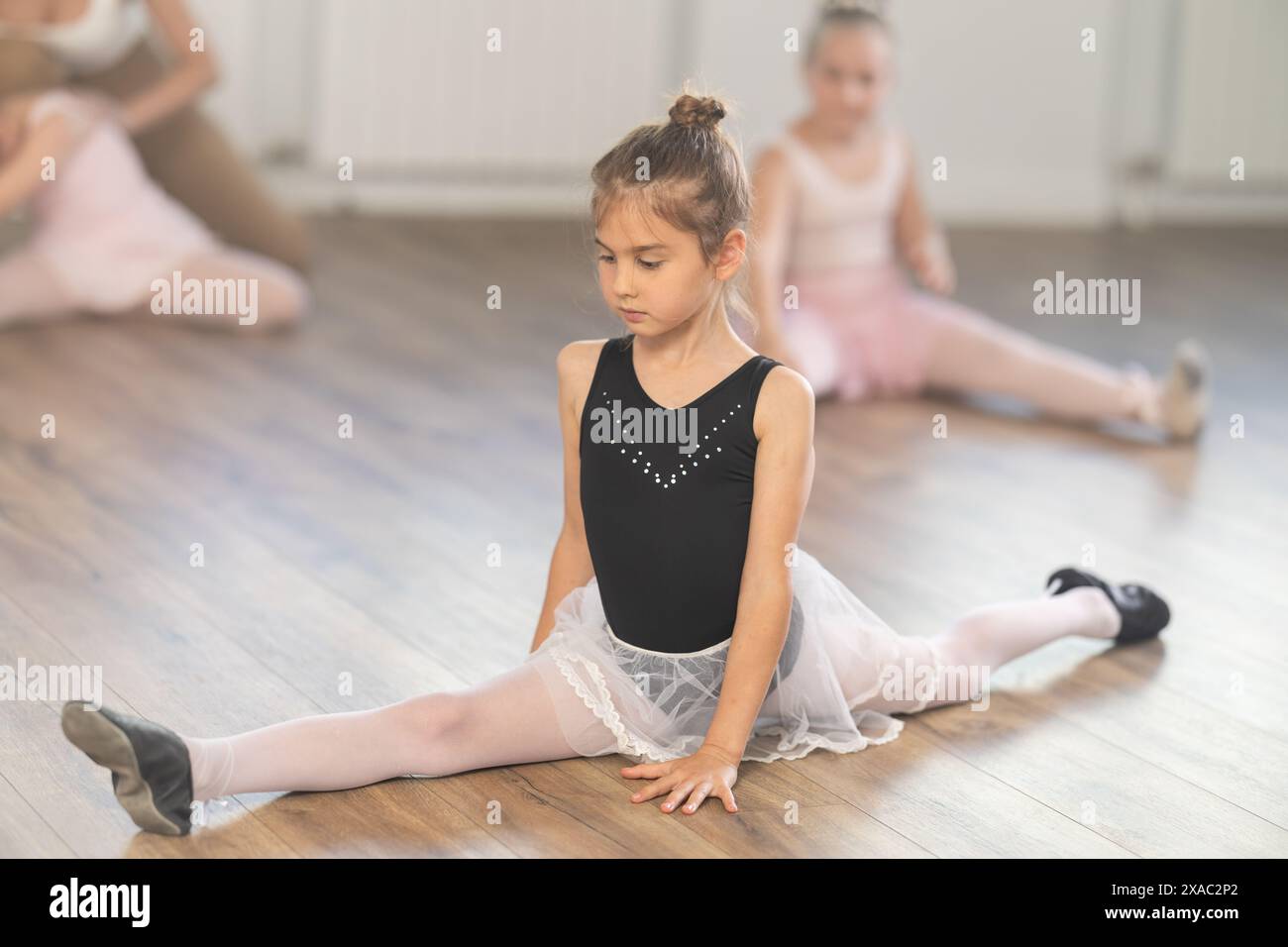 Little girls ballerinas learn to do the splits in dance class Stock ...