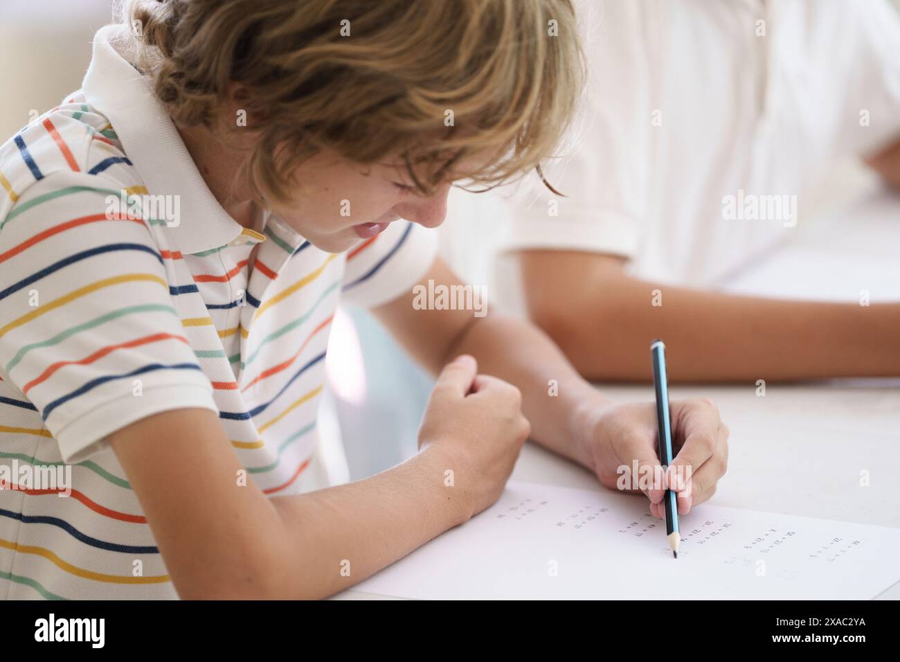 Child in school. Student in class. Boy doing homework. Homeschooling or ...
