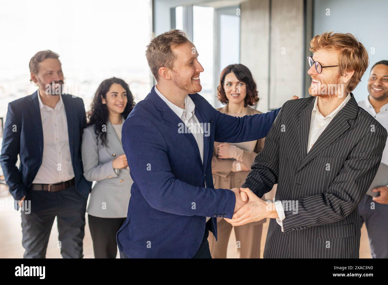 Two Men Business Professionals Shaking Hands In Modern Office Stock Photo - Alamy