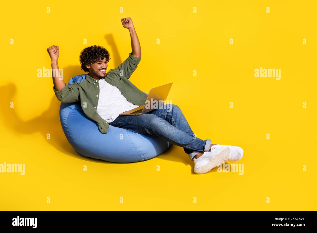 Full body length photo of successful guy lying pouf chilling playing ...