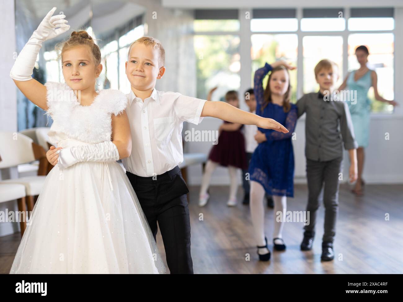 Tween girls ad boys dancing slow partner dance during festive event ...
