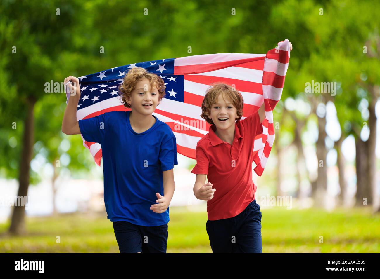 Happy 4th of July. USA supporter with national flag. Happy child ...