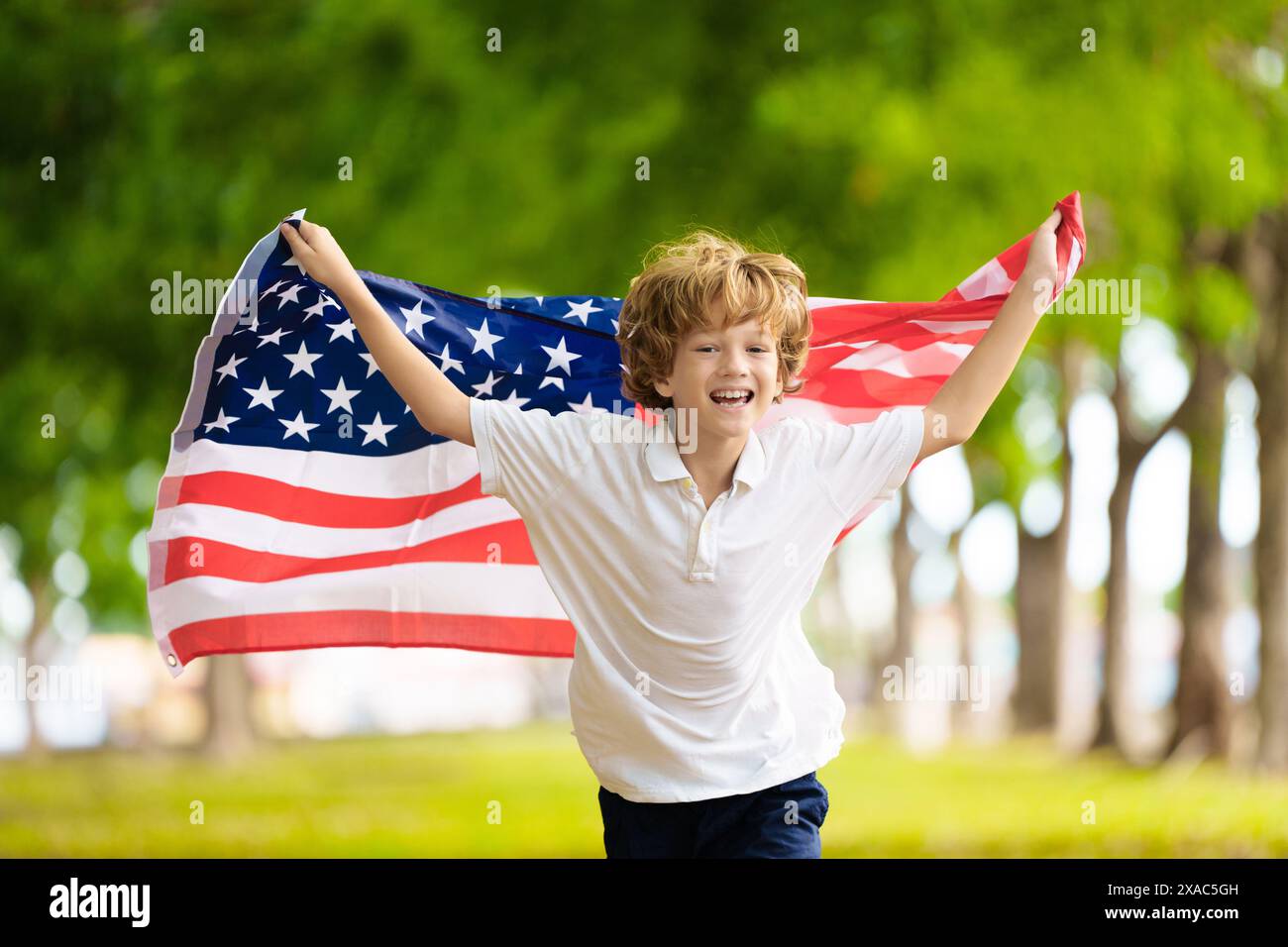 Happy 4th of July. USA supporter with national flag. Happy child ...