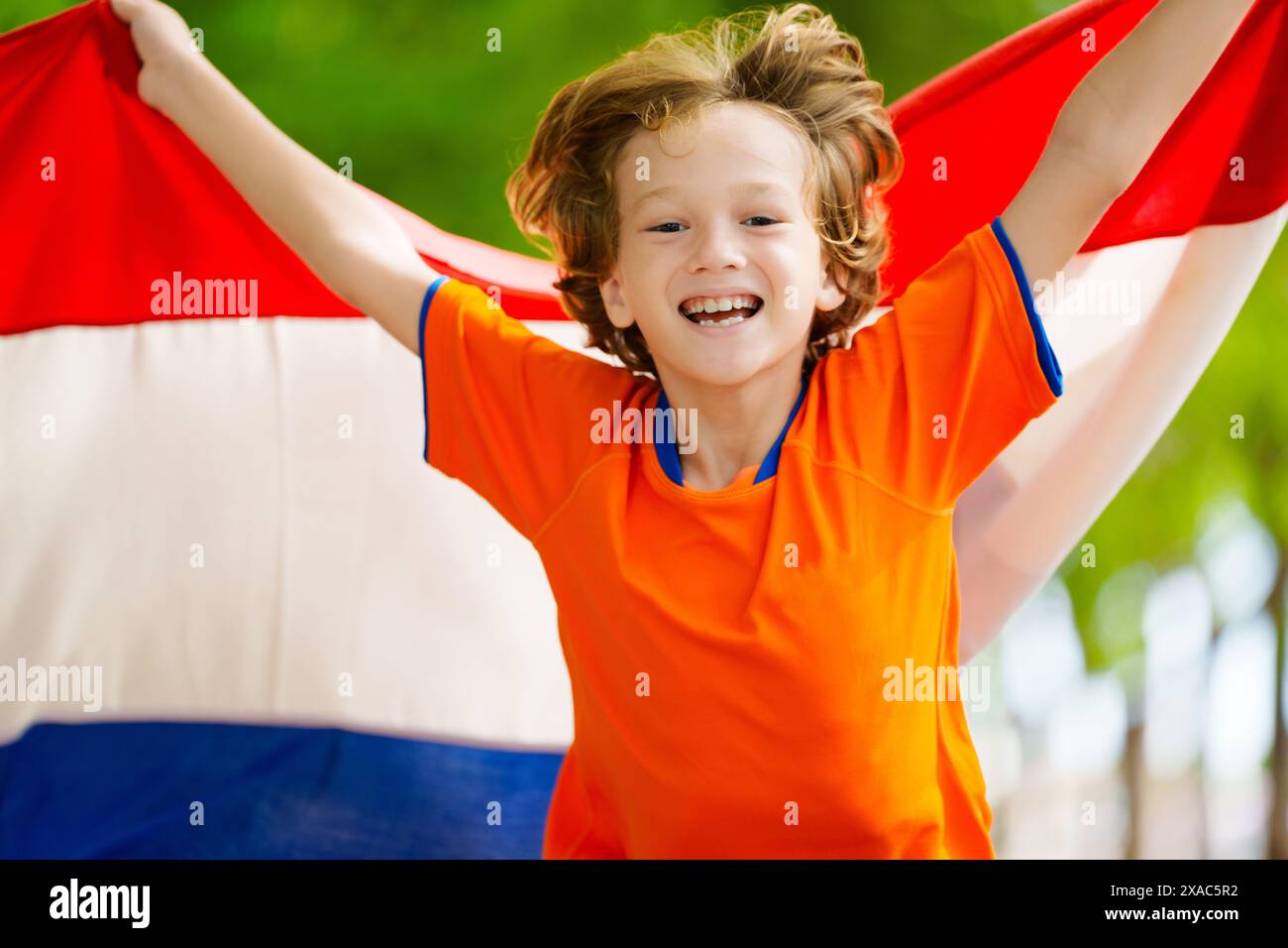 Netherlands football supporter child on stadium. Dutch fan kid running ...