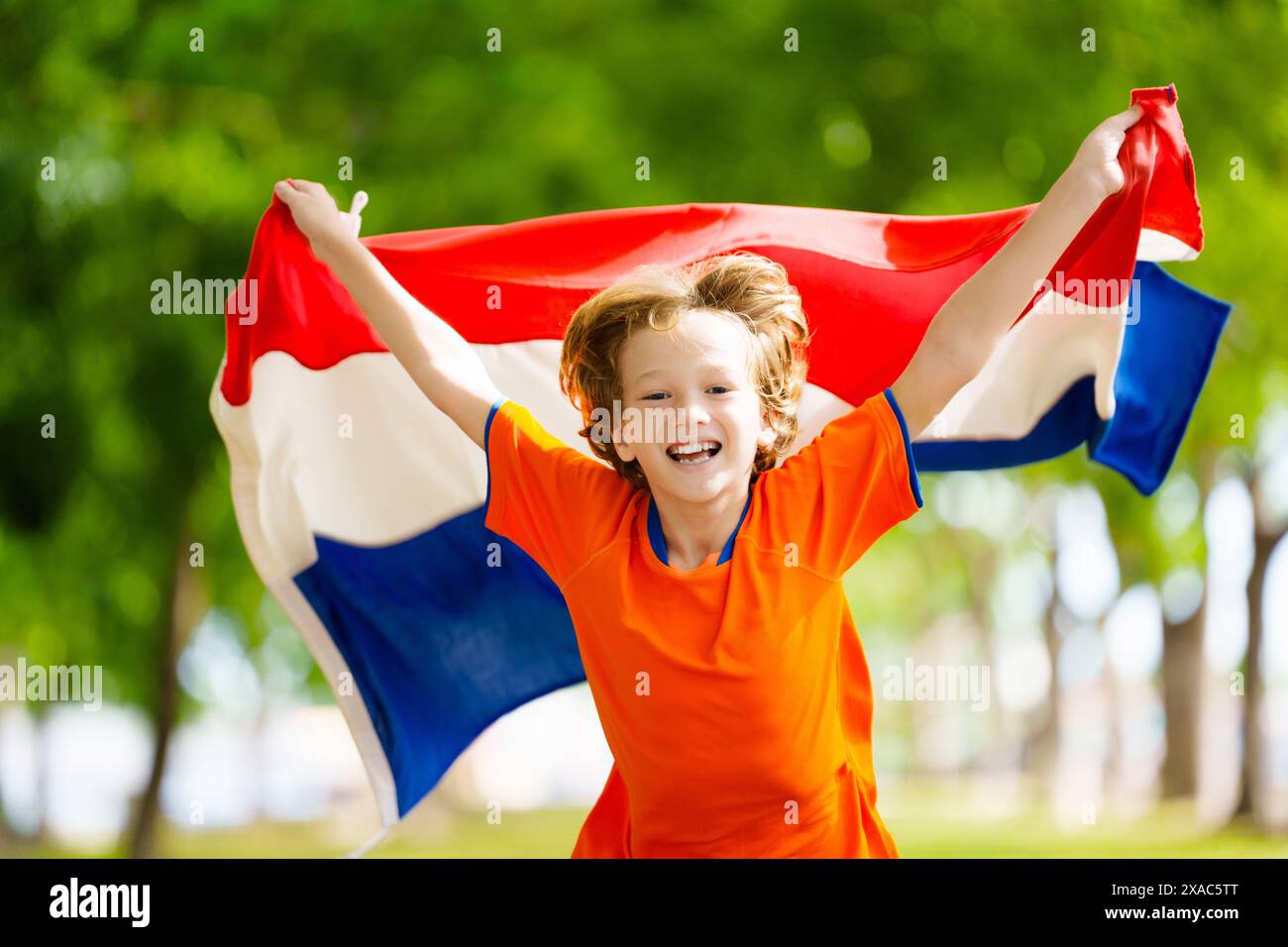 Netherlands football supporter child on stadium. Dutch fan kid running ...