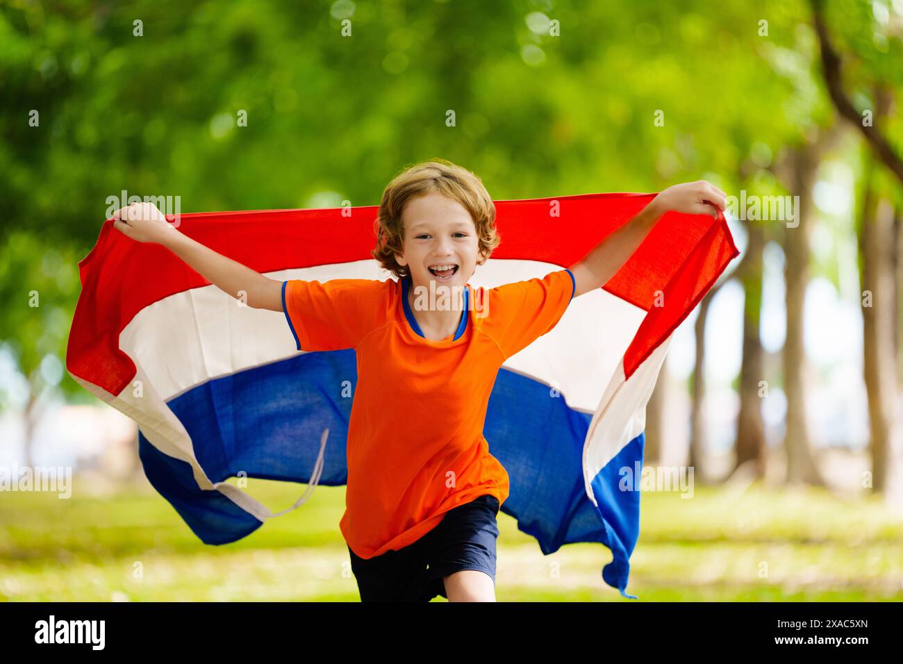 Netherlands football supporter child on stadium. Dutch fan kid running ...