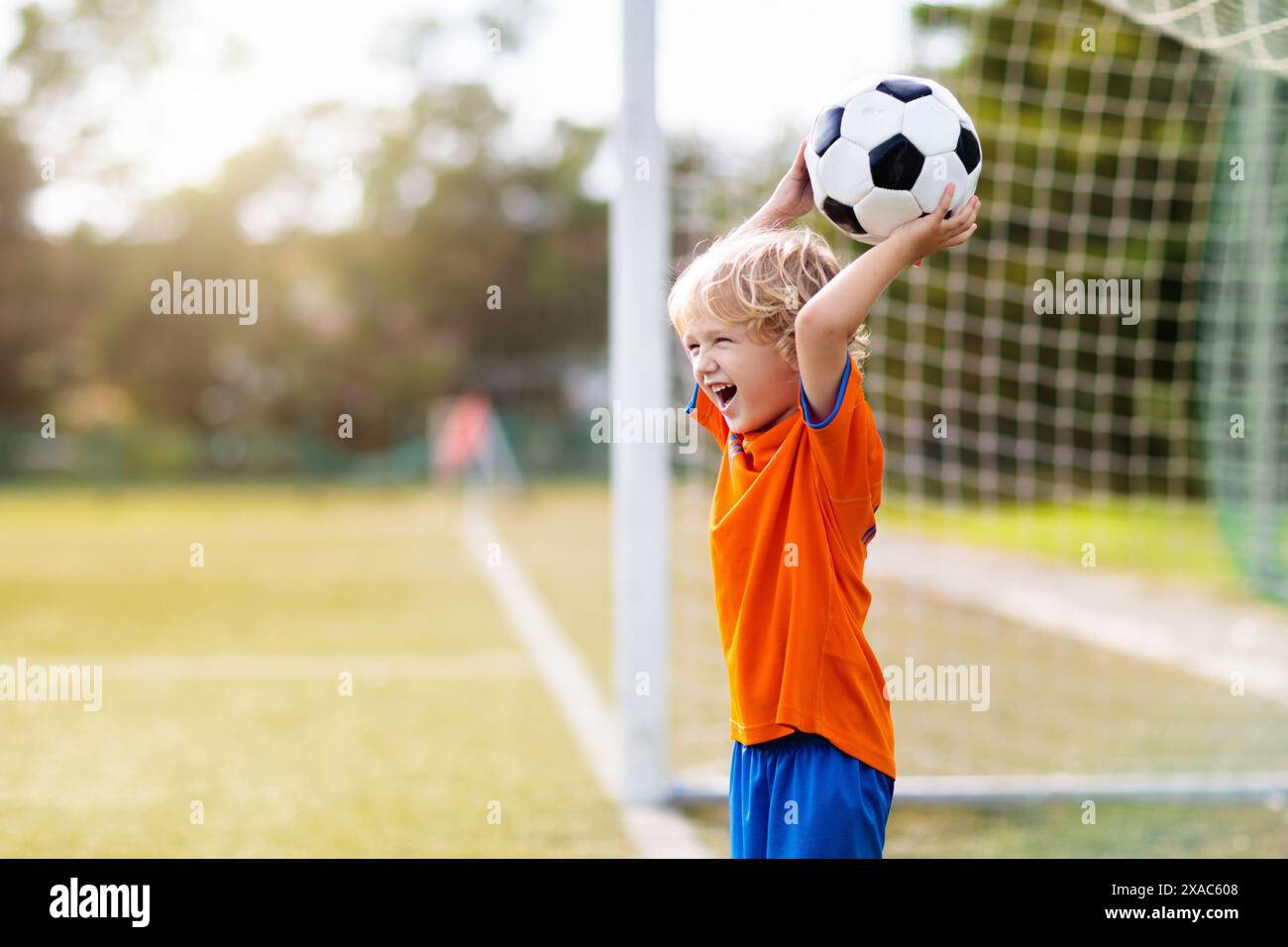 Dutch kids play football on outdoor field. Netherlands team fans with ...