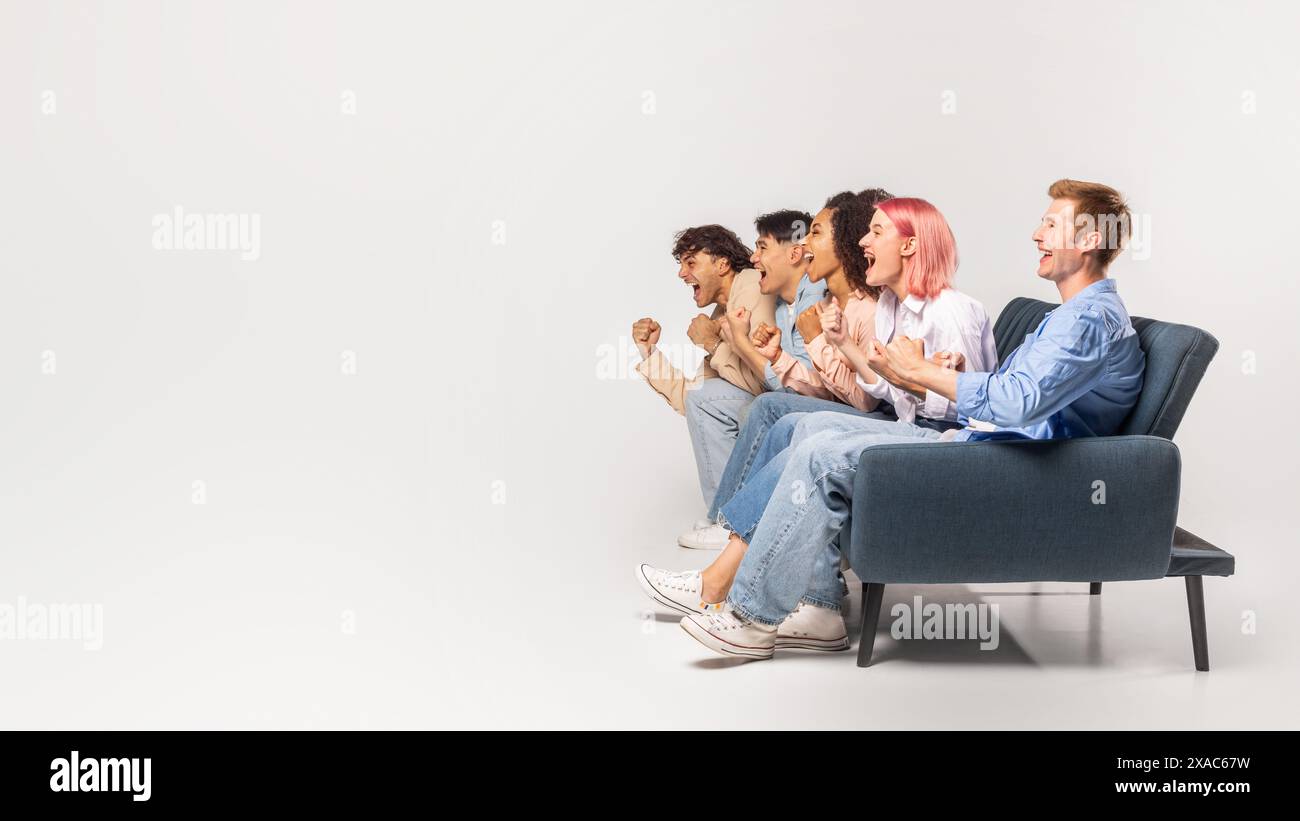 Diverse Group of Friends Cheer Excitedly While Sitting on Couch Stock ...