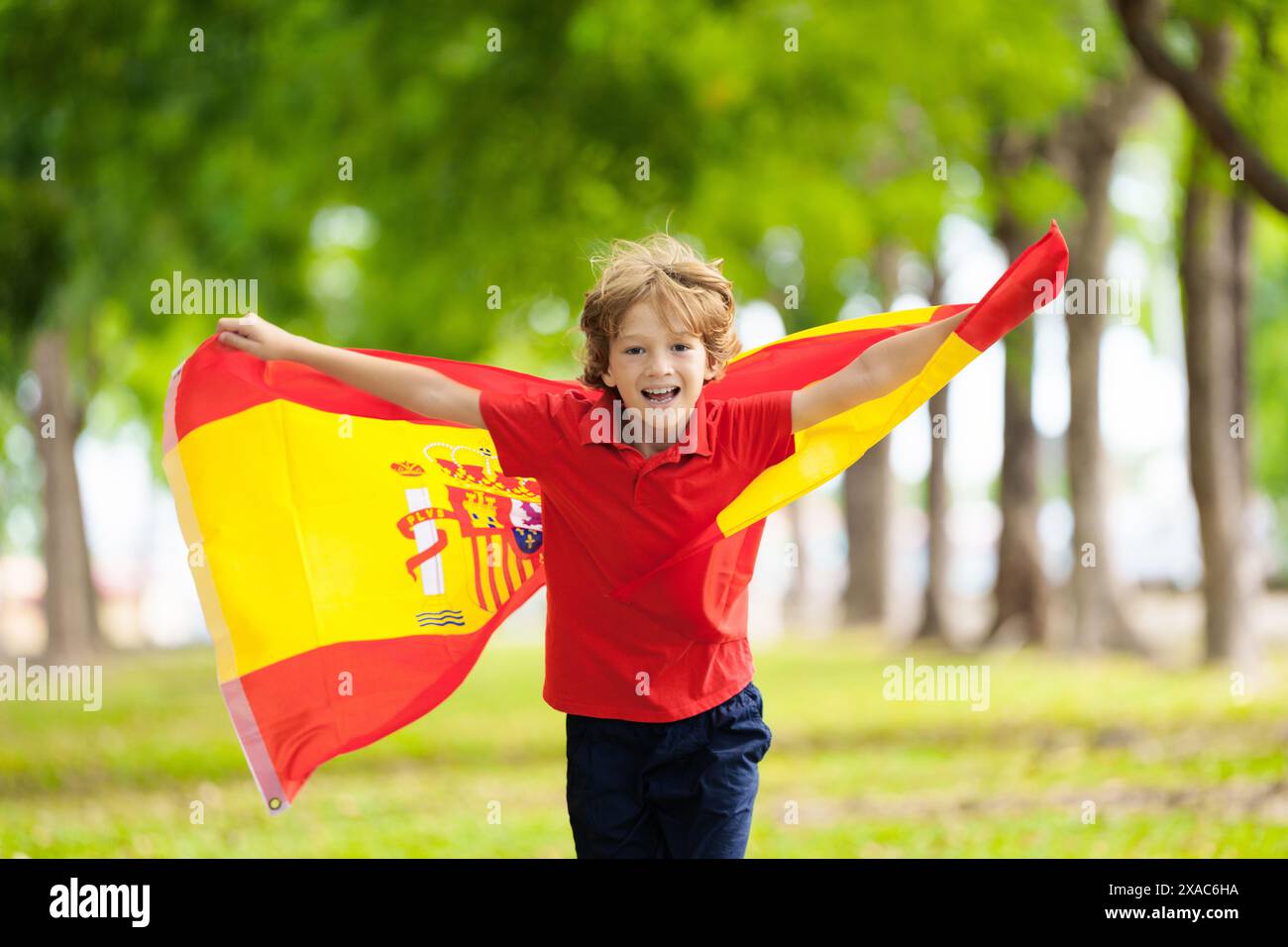 Child running with Spain flag. Little boy supporting Spanish football ...