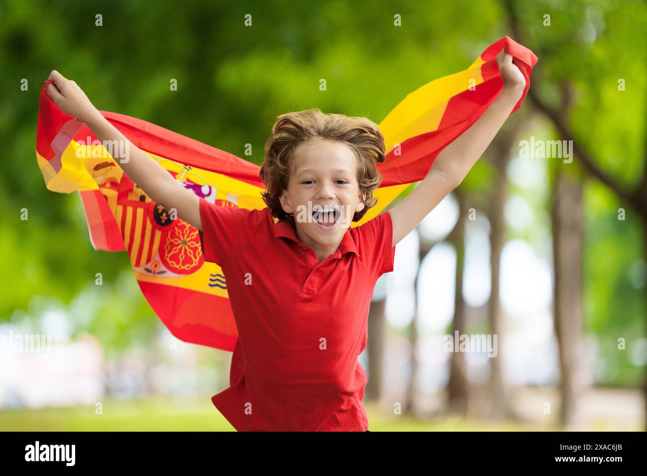 Child running with Spain flag. Little boy supporting Spanish football ...