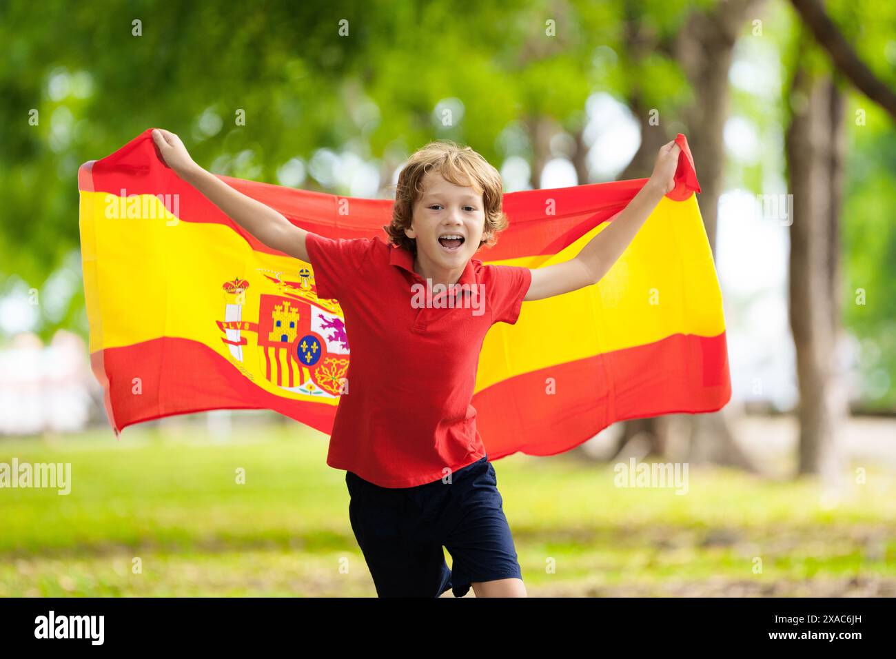 Child running with Spain flag. Little boy supporting Spanish football ...