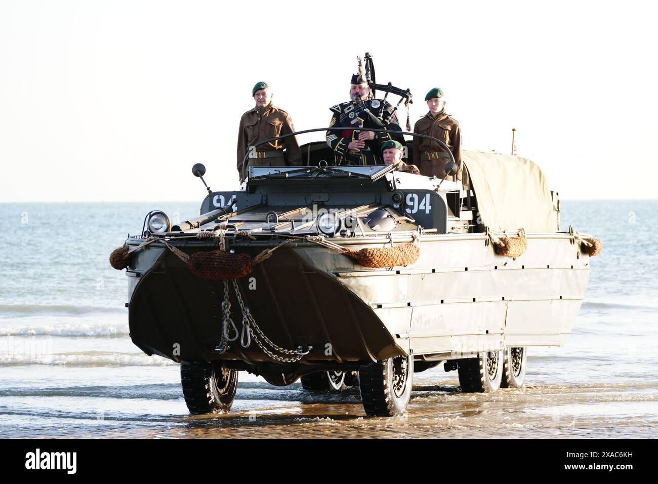 Military piper Major Trevor Macey-Lillie comes into shore on a DUKW ...