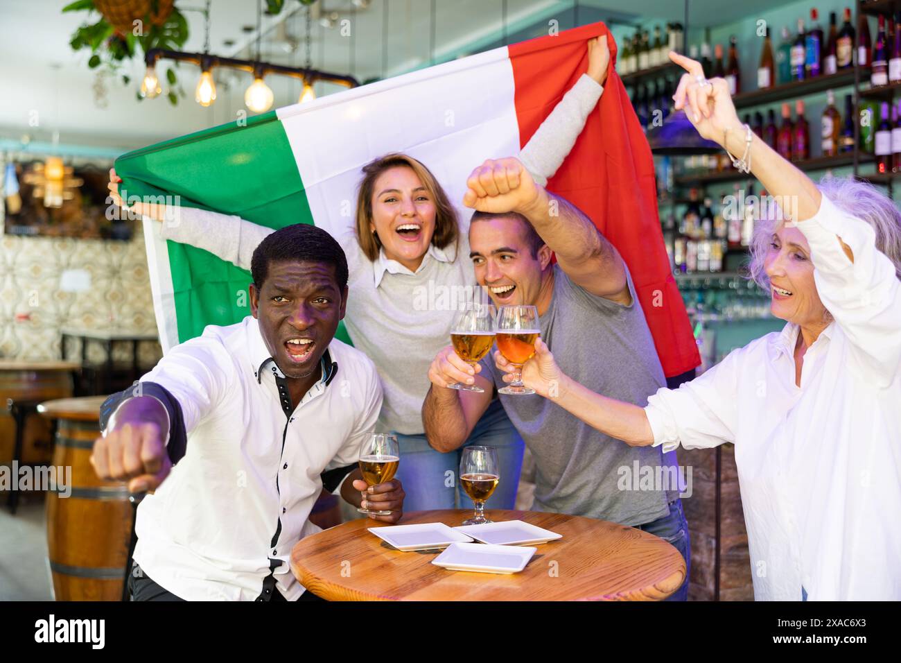 Diverse group celebrating with Italian flag Stock Photo - Alamy