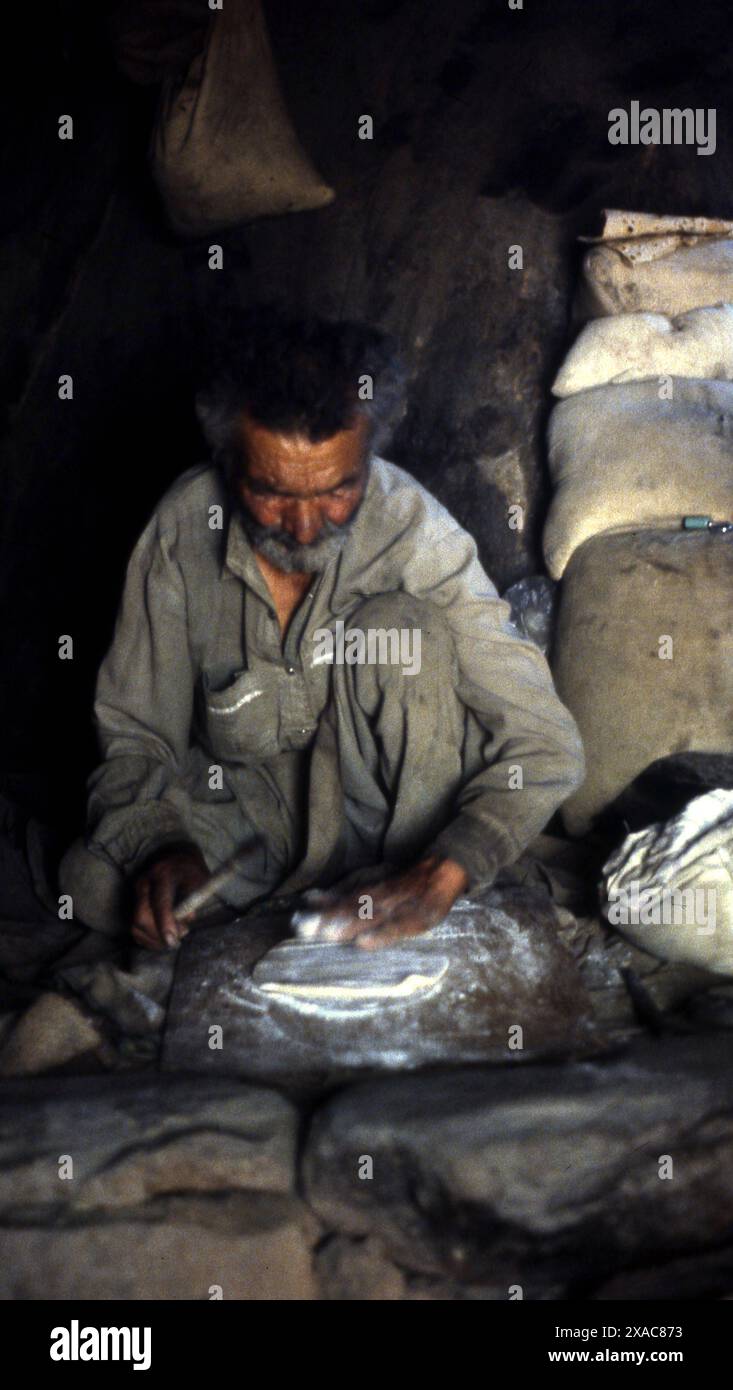 Shepherd cooking in cave summer encampment near Passu, Hunza Valley ...