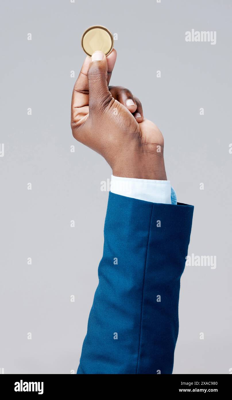 Investment, hand and gold coin in studio grey background for crypto ...