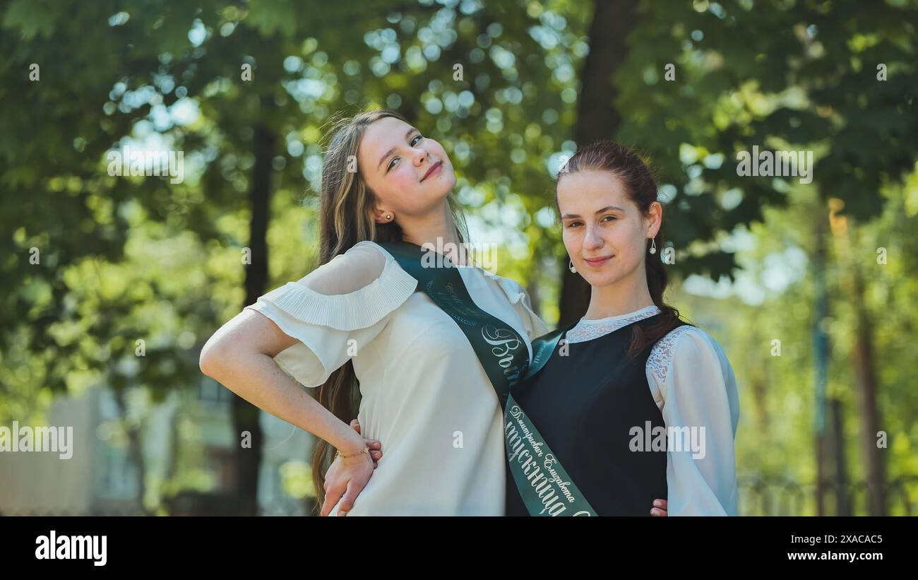 Two Russian schoolgirls graduate posing on a summer day Stock Photo - Alamy
