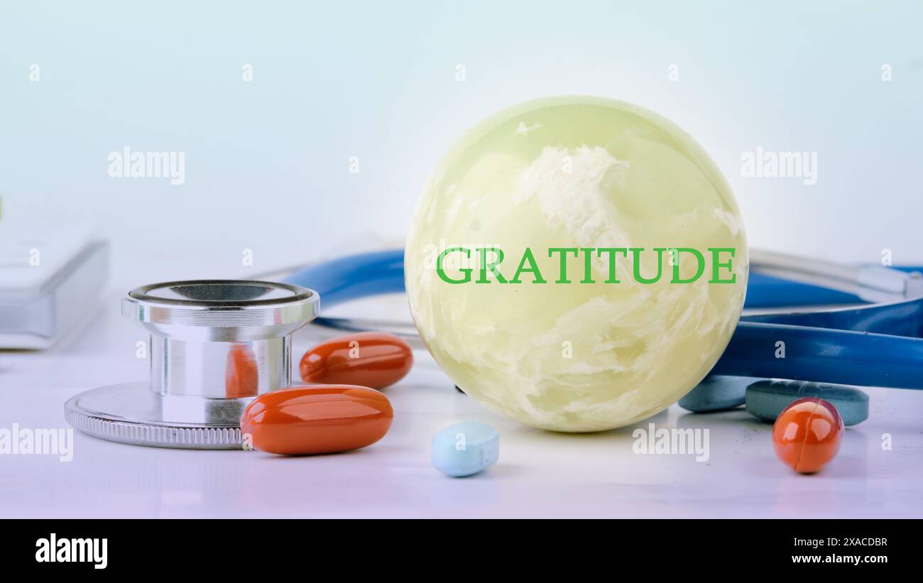 Top view of words GRATITUDE written on a ball on a blue background with ...