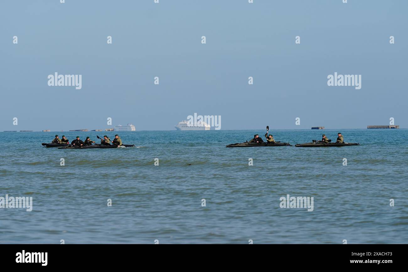 A beach landing by the Royal Marines of 47 Commando and civilians at ...