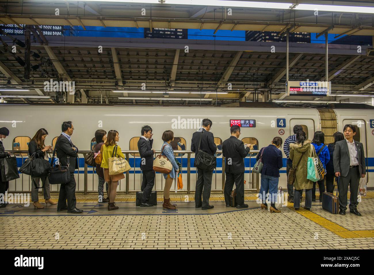 Passengers waiting in line in the Shinkanzen train station, Tokyo, Honshu, Japan, Asia Copyright ...