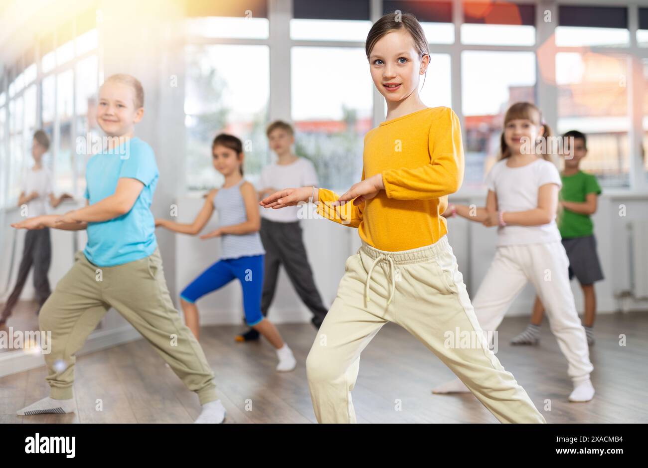 Girl learn to dance hip hop dances, doing movement with unrecognizable ...