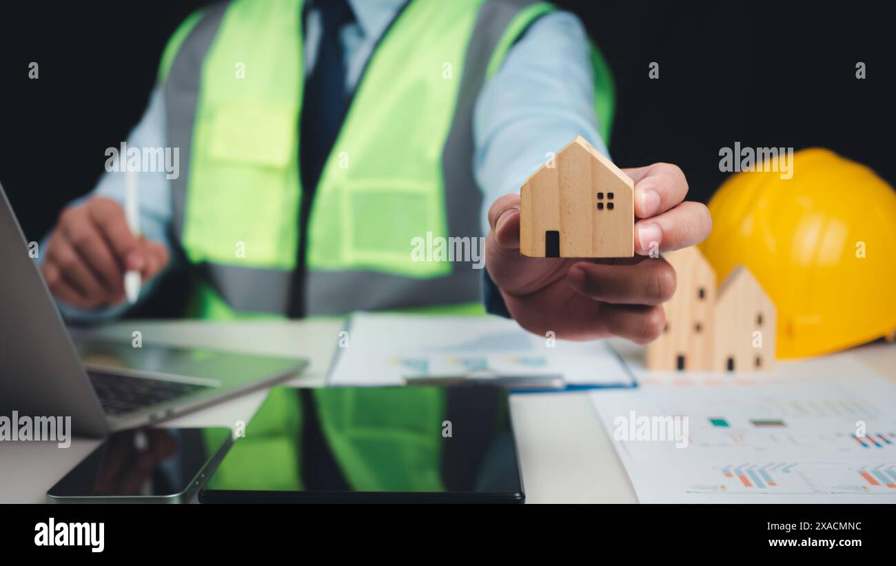 Architect or engineer using tablet to work on table, Construction ...