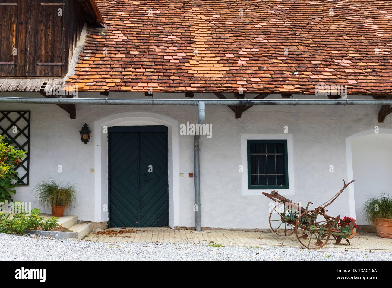 photography of an old traditional Alpine farmhouse with white walls ...