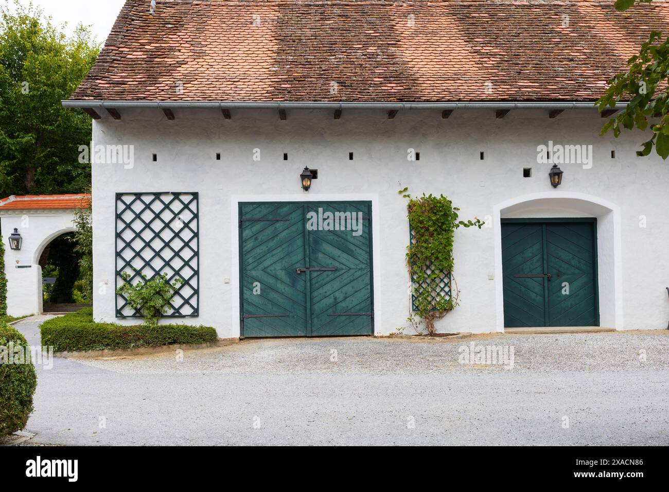 photography of an old traditional Alpine farmhouse with white walls ...
