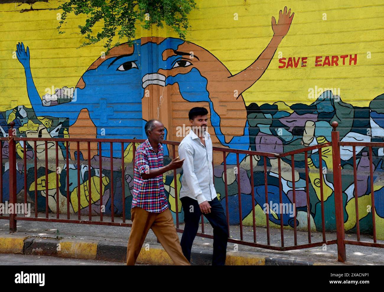 MUMBAI, INDIA - JUNE 5: A pedestrian walks past a mural, made to create ...