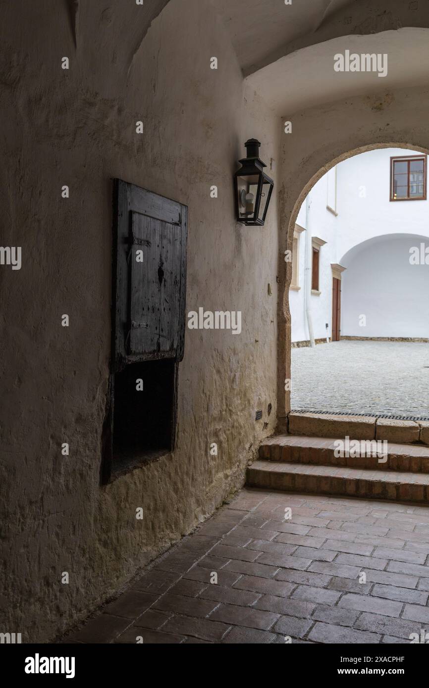 photography of an arch in an inner courtyard of old medieval Alpine ...