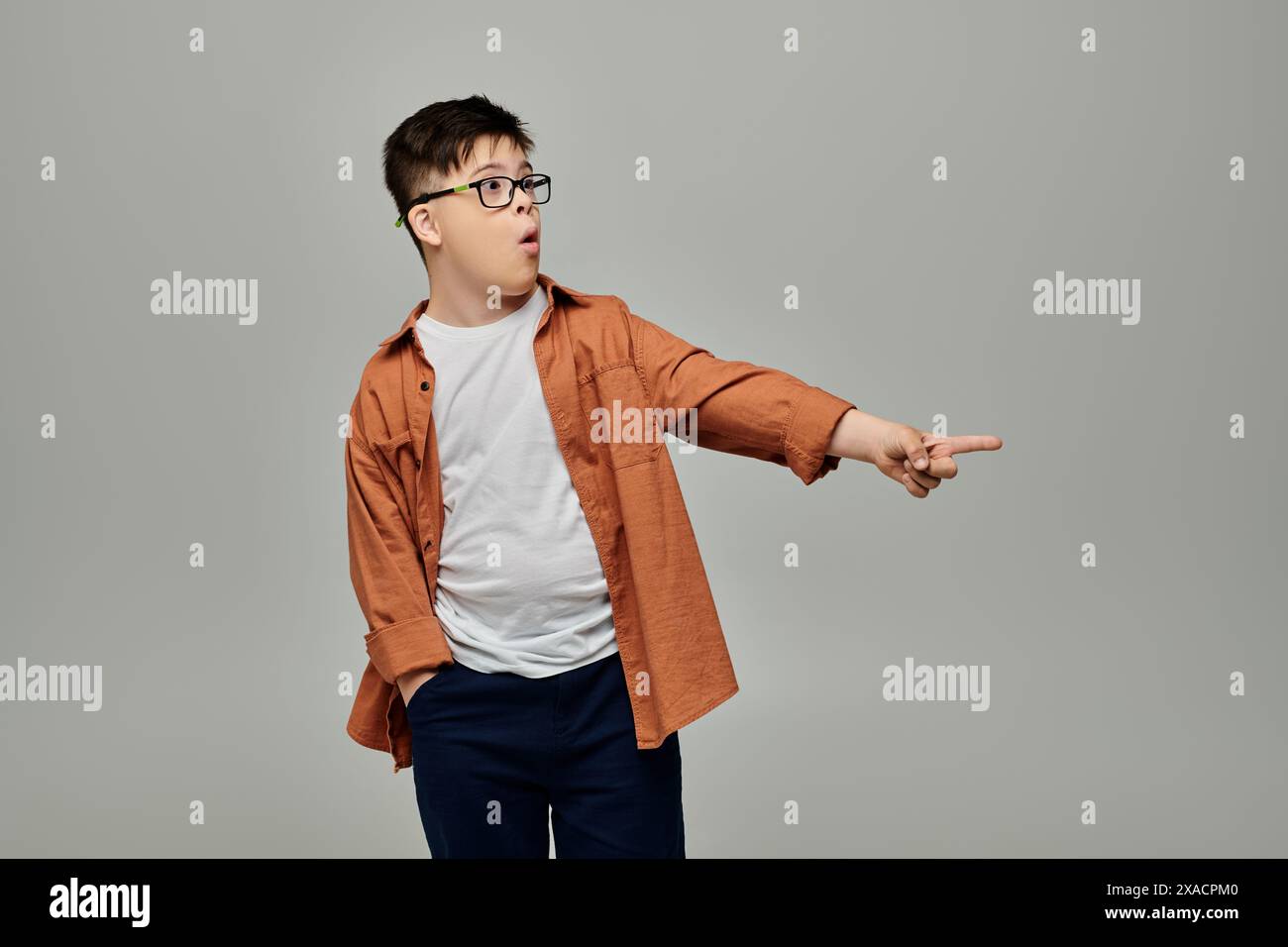 little kid with Down syndrome with glasses pointing excitedly Stock ...