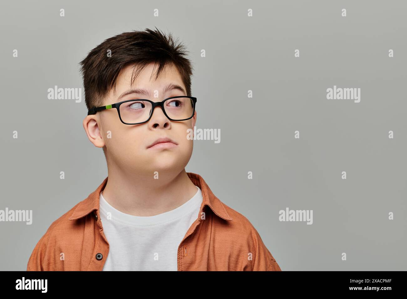 A kid with Down syndrome wearing glasses Stock Photo - Alamy