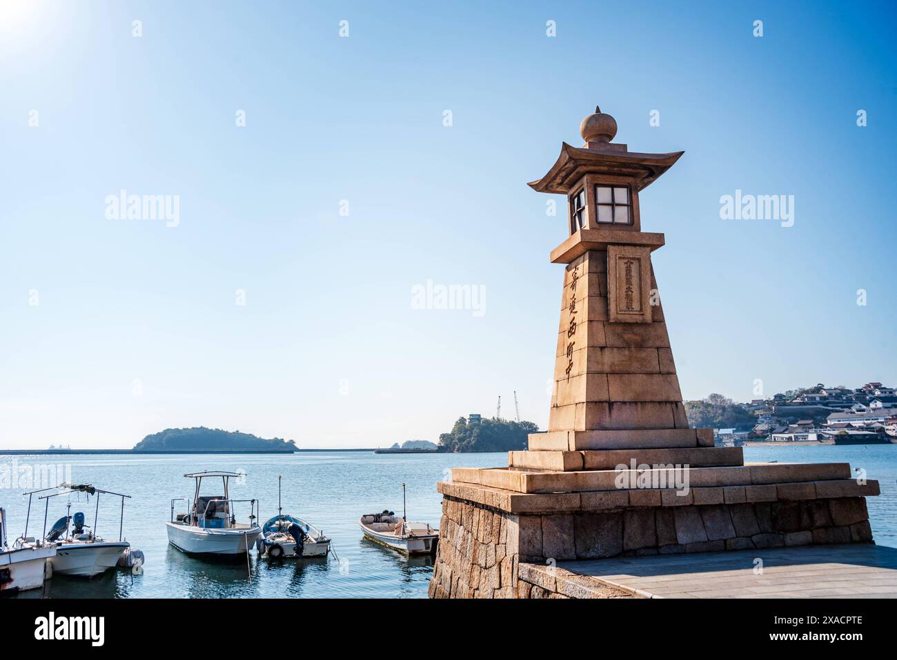 Beautiful Japanese stone lantern style lighthouse at the blue sea in ...