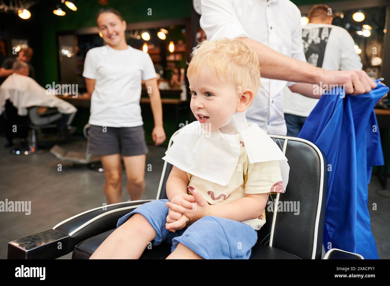 Adorable kid excited about new haircut. Little boy first time in ...