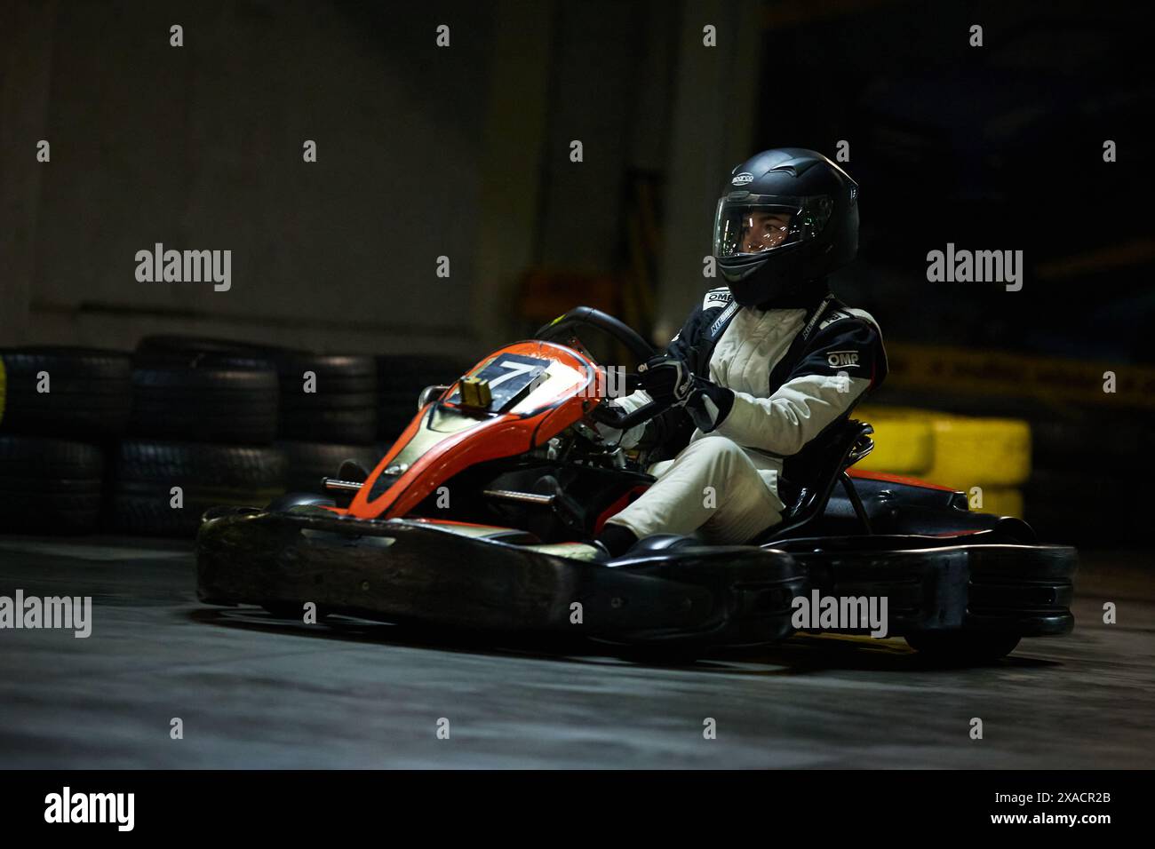 Female Go Kart racer driving fast on a indoor race track. Kyiv - 26 ...