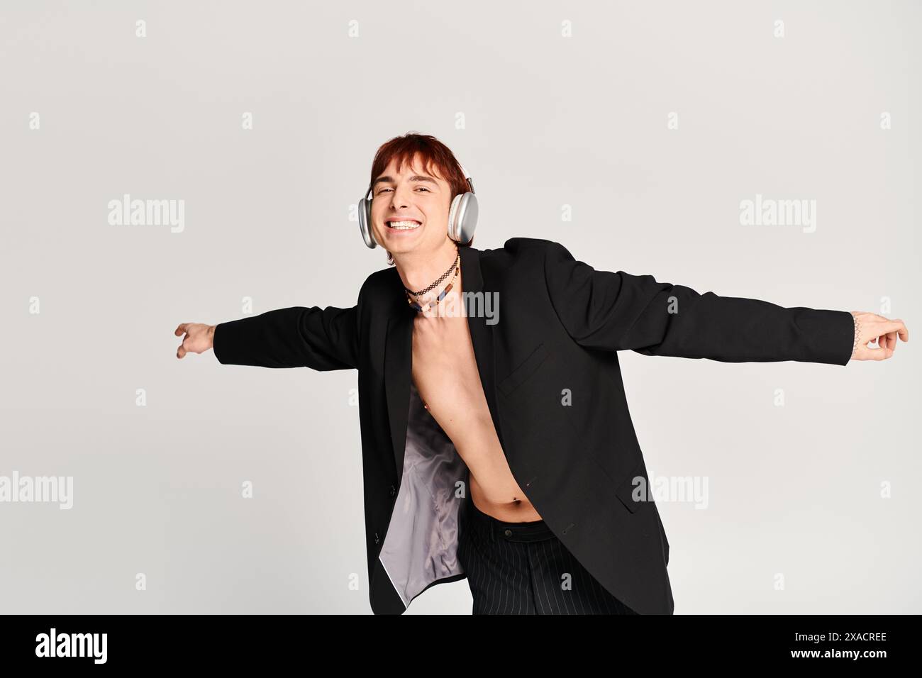 Stylish young man striking poses in a studio setting, showcasing his ...