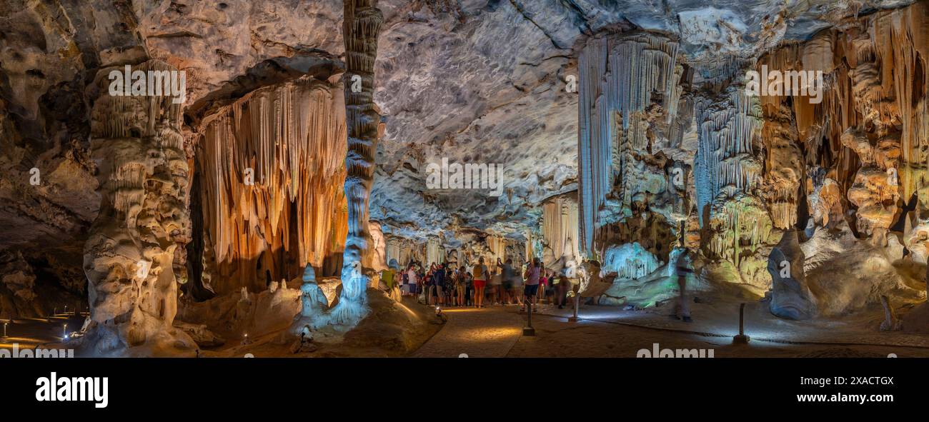 View of visitors viewing stalagmites and stalactites in the interior of ...